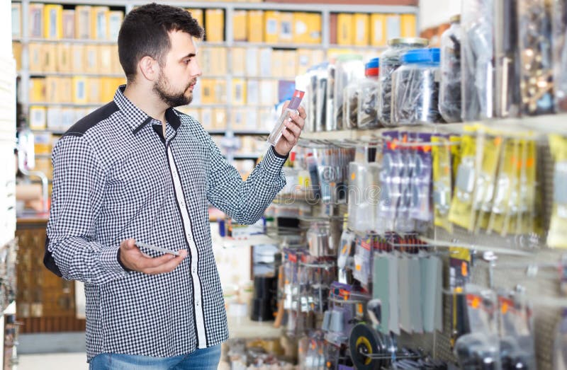 Man Deciding on Best DIY Details in Houseware Store Stock Image - Image ...