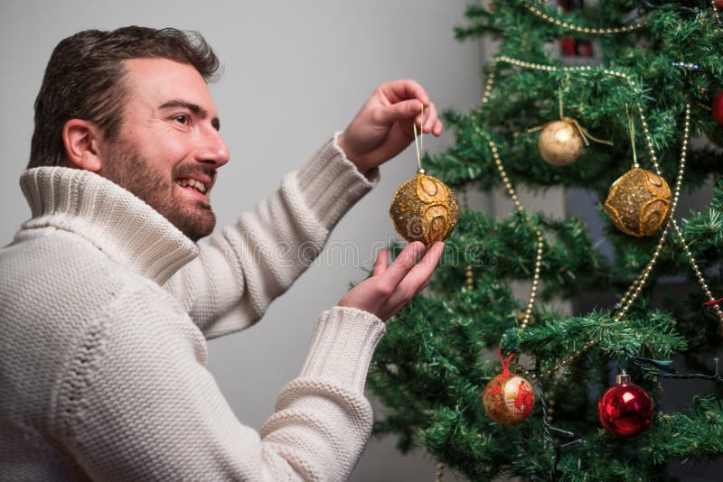 Man Decorating a Christmas Tree with Golden Balls Stock Photo - Image ...
