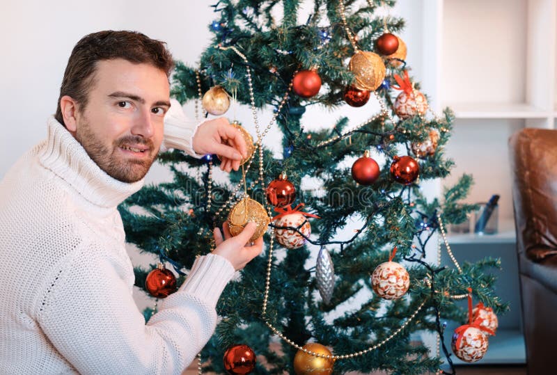 Man Decorating a Christmas Tree with Golden Balls Stock Photo - Image ...
