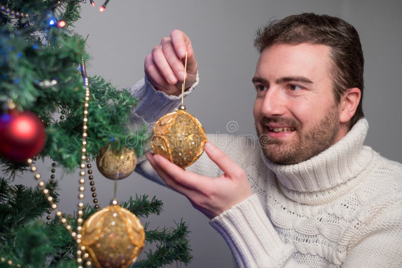 Man Decorating a Christmas Tree with Golden Balls Stock Image - Image ...
