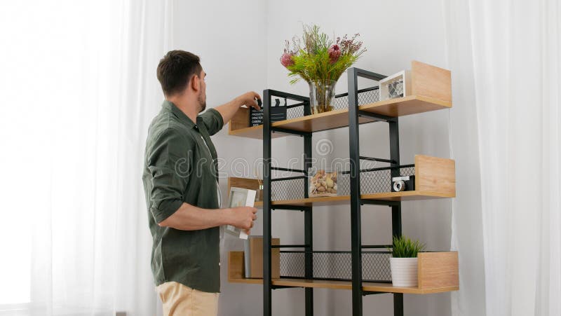 Man Decorating Home and Arranging Shelf Stock Image - Image of ...