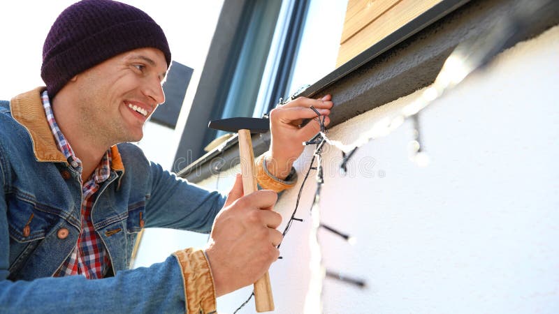 Man Decorating House with Christmas Lights Stock Photo - Image of ...