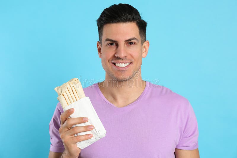 Man with Delicious Shawarma on Turquoise Background Stock Image - Image ...