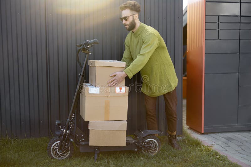 Man Delivers Goods by Electric Scooter Stock Image - Image of packages ...