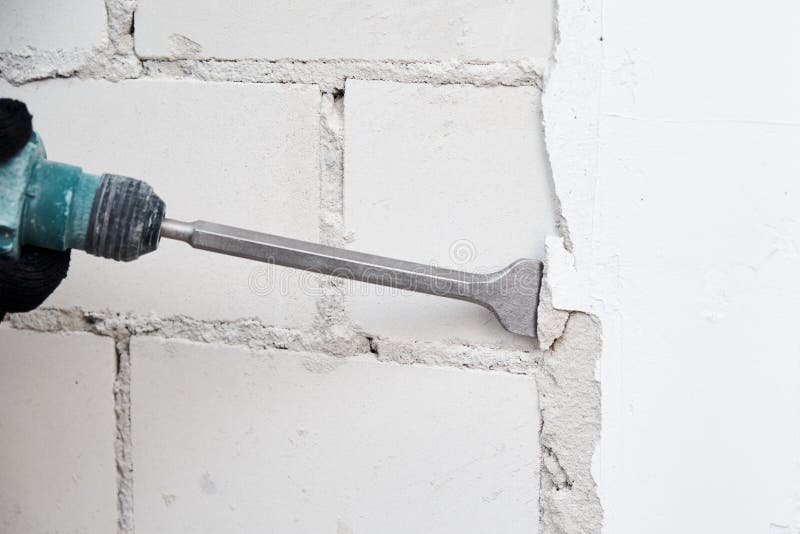 Man with Demolition Hammer Remove Stucco from Wall. Renovation Concept ...