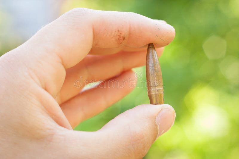 A Man Demonstrating a Bullet Stock Image - Image of weapon, caliber ...