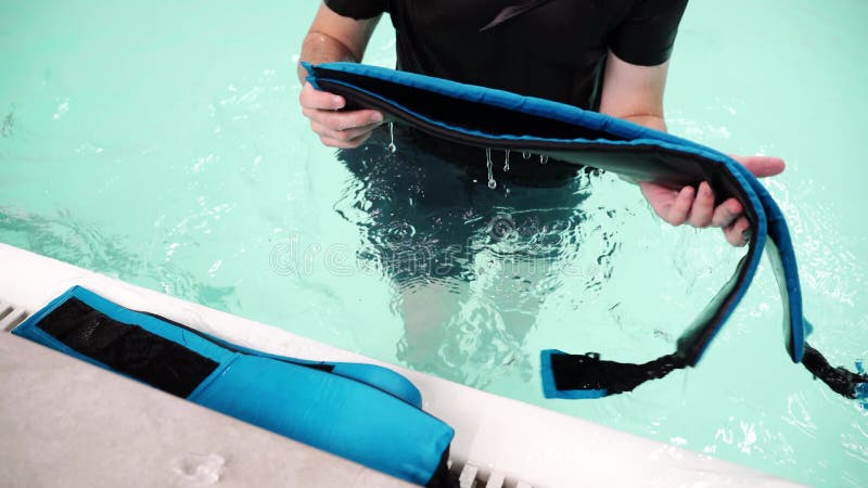 Man Demonstrating Use of Blue Floatation Device in Pool for Safety and ...
