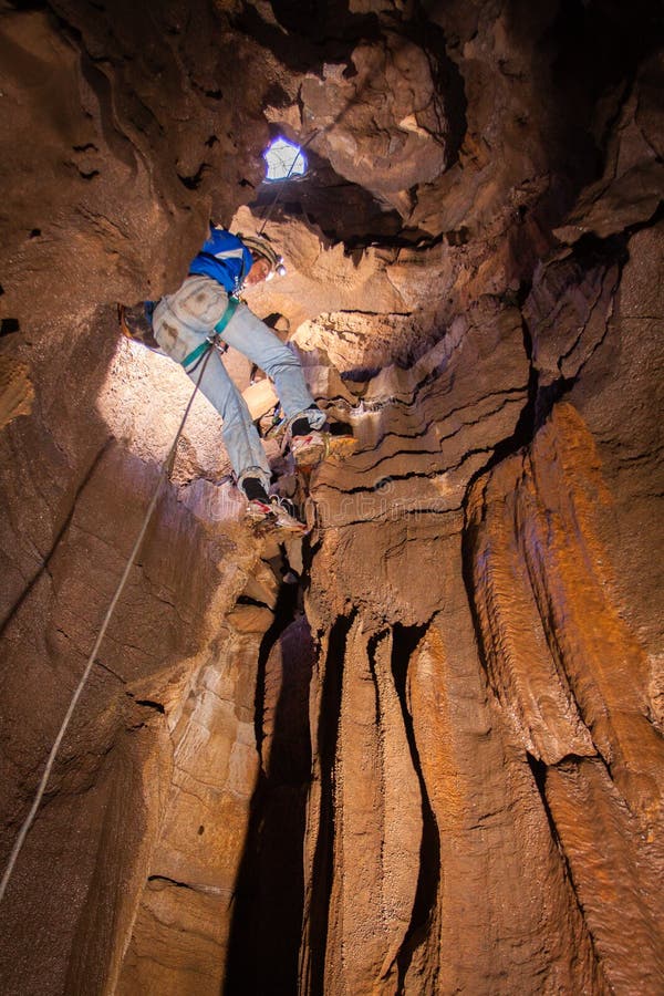 Man descending into cave stock photo. Image of safe, enter - 29173788