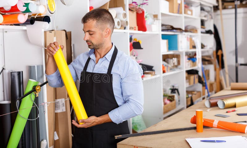 Man Designer and Print Operator with Vinyl Paper at Print Manufacturing ...