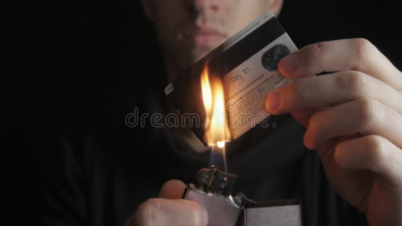 Man Destroys a Credit Card. a Guy Burns a Credit Card with a Cigarette ...