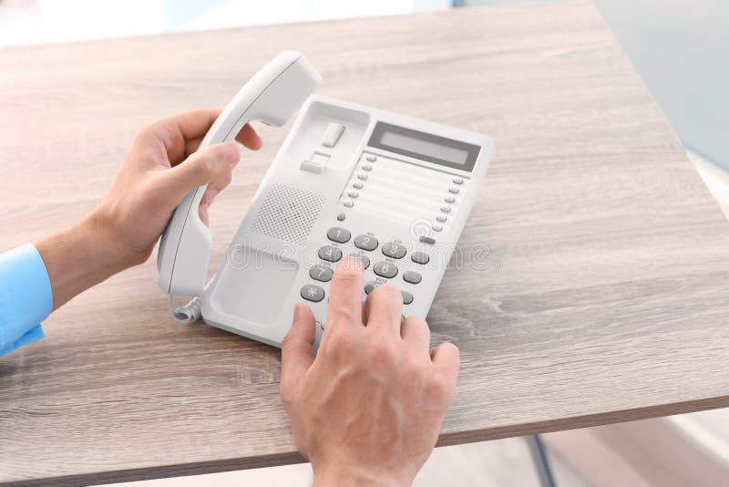 Man Dialing Number on Telephone at Table Stock Photo - Image of ... Man Dialing Number on Telephone at Table Stock Photo - Image of ...