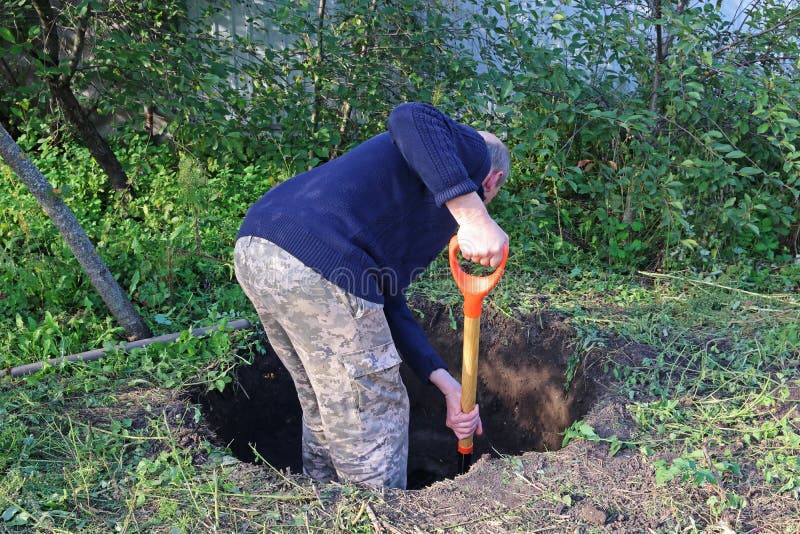 Man Digs a Deep Pit. Digging a Pit by Shovel Stock Photo - Image of ...