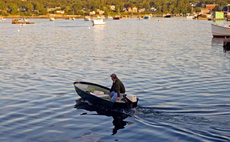 Man in dingy stock image. Image of motorboat, coastline - 2862401