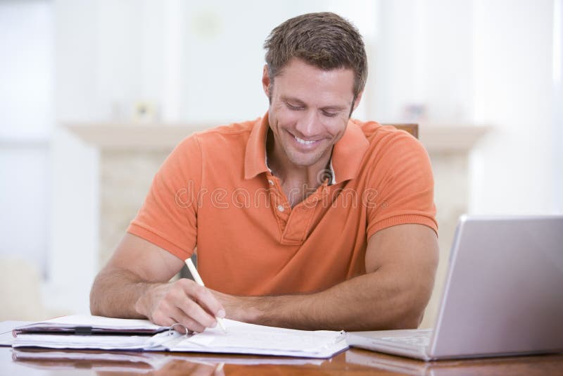 Man in Dining Room with Laptop Writing and Smiling Stock Photo - Image ...