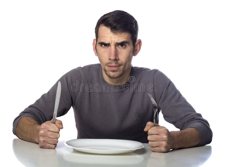 Man at Dinner Table with Fork and Knife Raised. Stock Image - Image of ...
