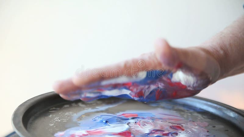 Man dips hand in paint stock video. Video of studio - 160128483