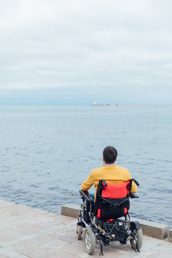 A Man with Disabilities Breathes Sea Air by the Sea Stock Photo - Image ...