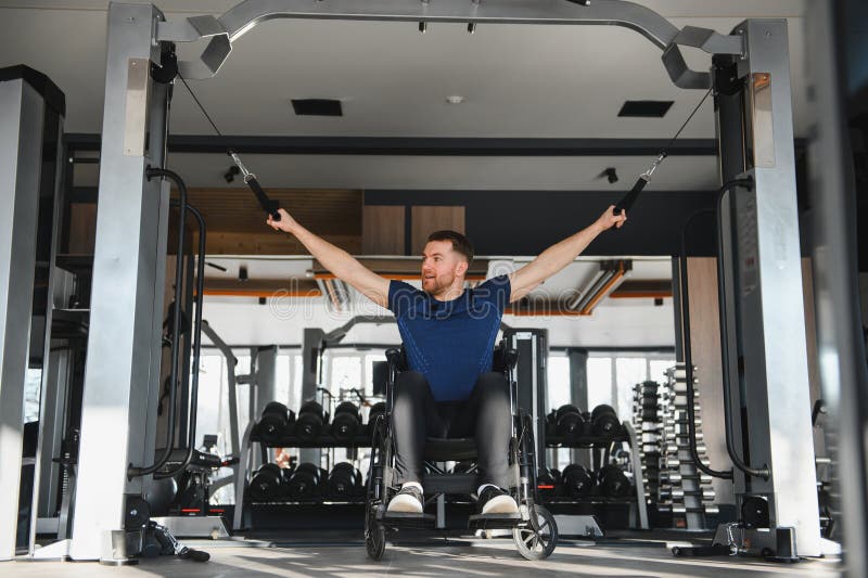 Man in Wheelchair Exercising with Cable Machine in Gym Stock Photo ...