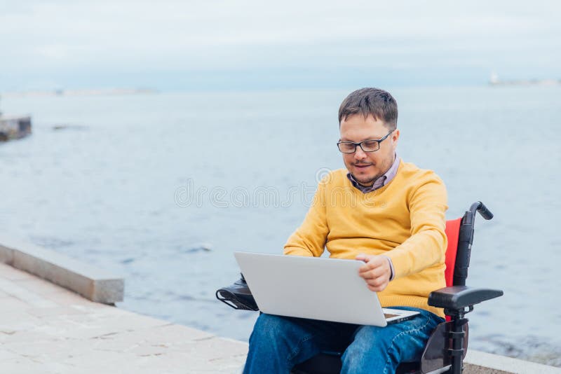 A Man with a Disability in a Disabled Working Business Remotely Stock ...