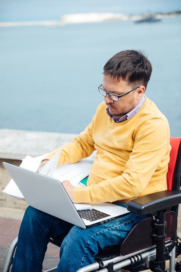 A Man with a Disability in a Disabled Working Business Remotely Stock ...