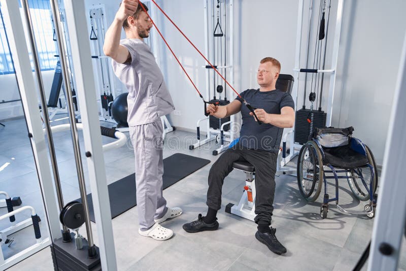 Man with Disability Do Strength Exercise for Hand with Physiotherapist ...