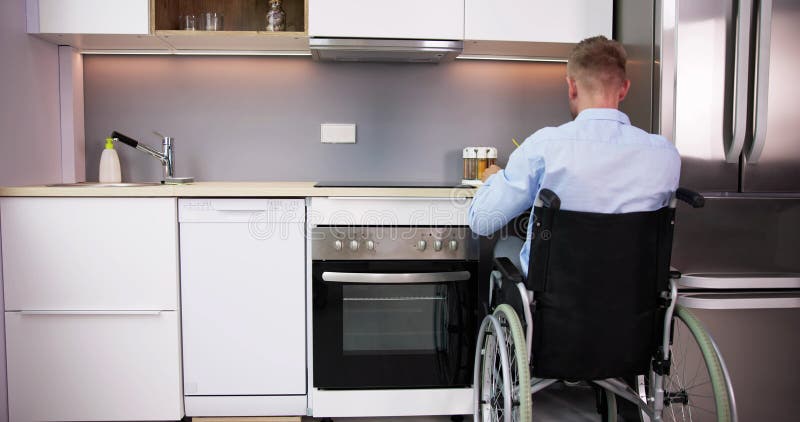 Man with Disability Sitting in Wheel Chair Preparing Food Stock Image ...