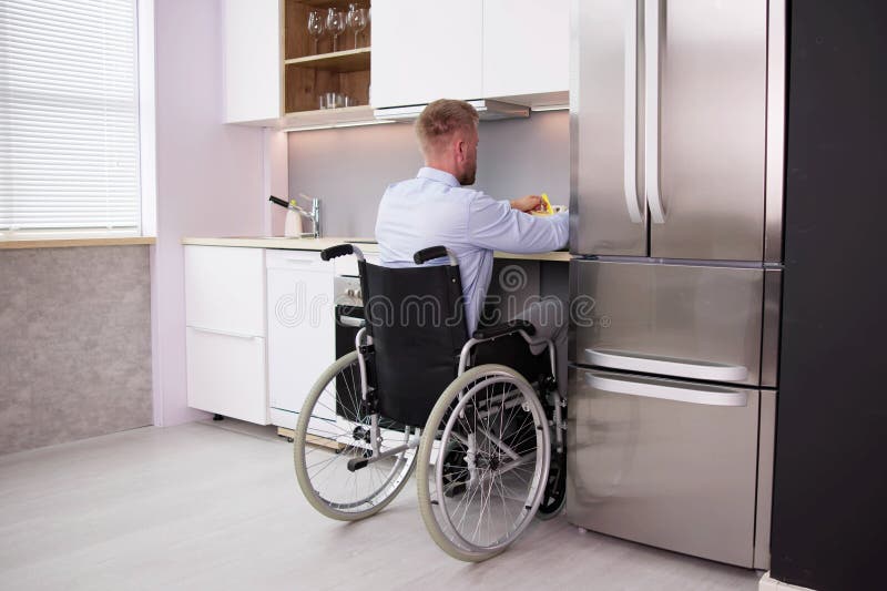 Man with Disability Sitting in Wheel Chair Preparing Food Stock Photo ...