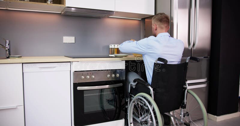 Man with Disability Sitting in Wheel Chair Preparing Food Stock Image ...