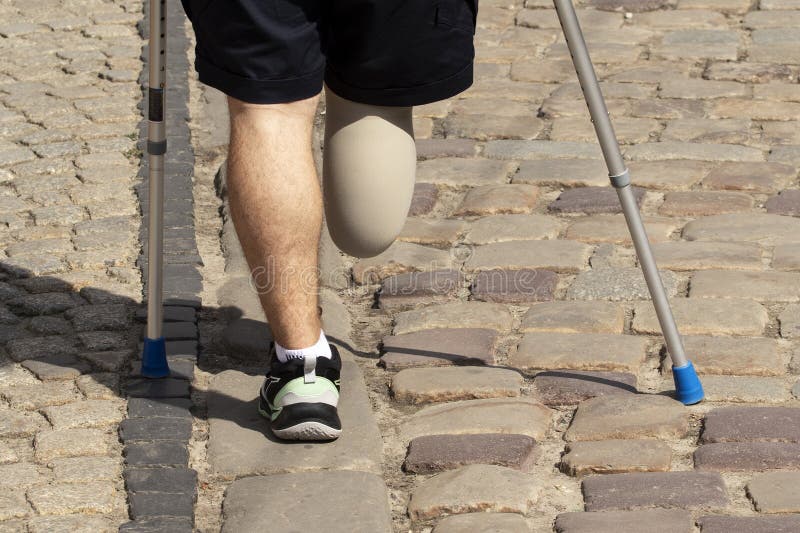 A Man with a Disability Walks on the Sidewalk. Stock Photo - Image of ...