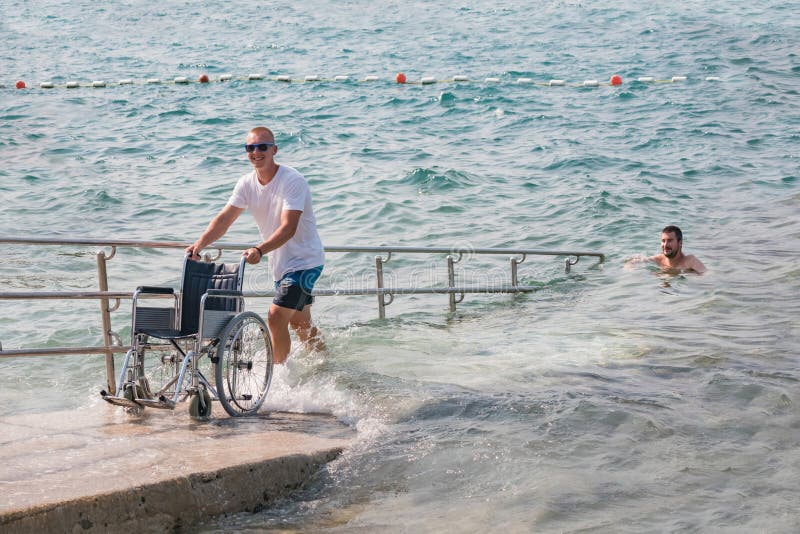 Man with Disability on Wheelchair at Beach Stock Photo - Image of ...