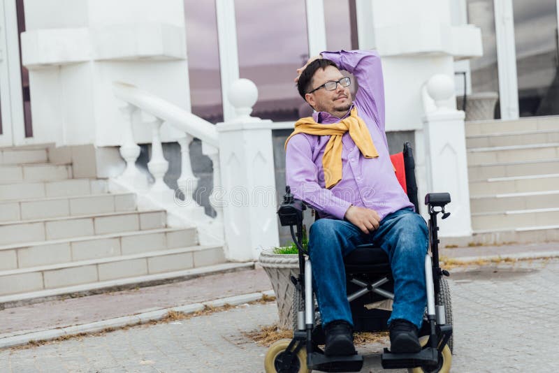 A Man with a Disability in a Wheelchair Enjoys the View Stock Photo ...