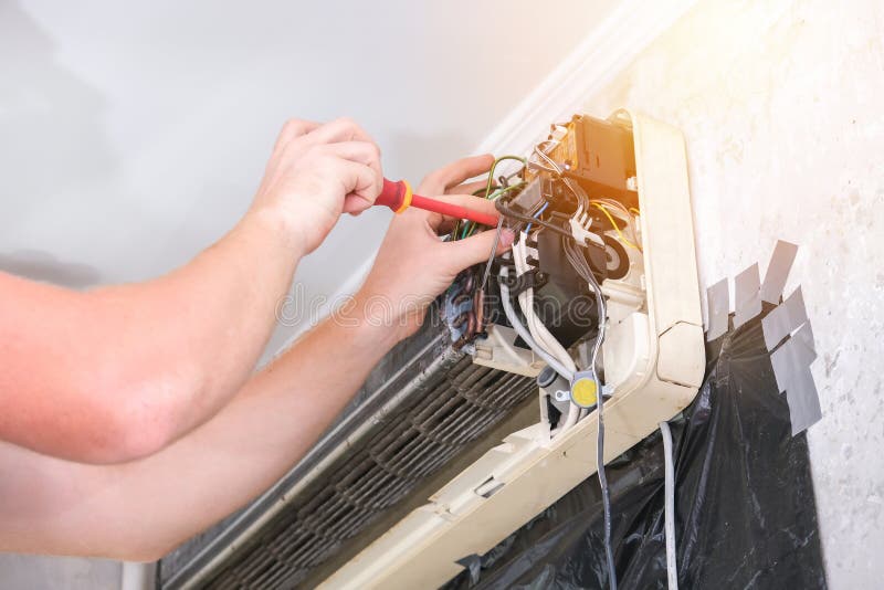 Man Disassembles an Air Conditioner for Repair and Cleaning. Split ...