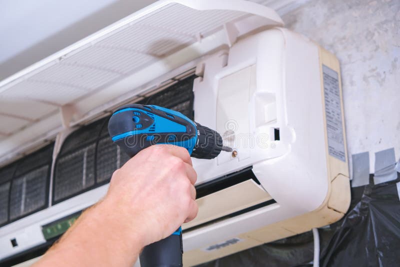 Man Disassembles an Air Conditioner for Repair and Cleaning. Split ...