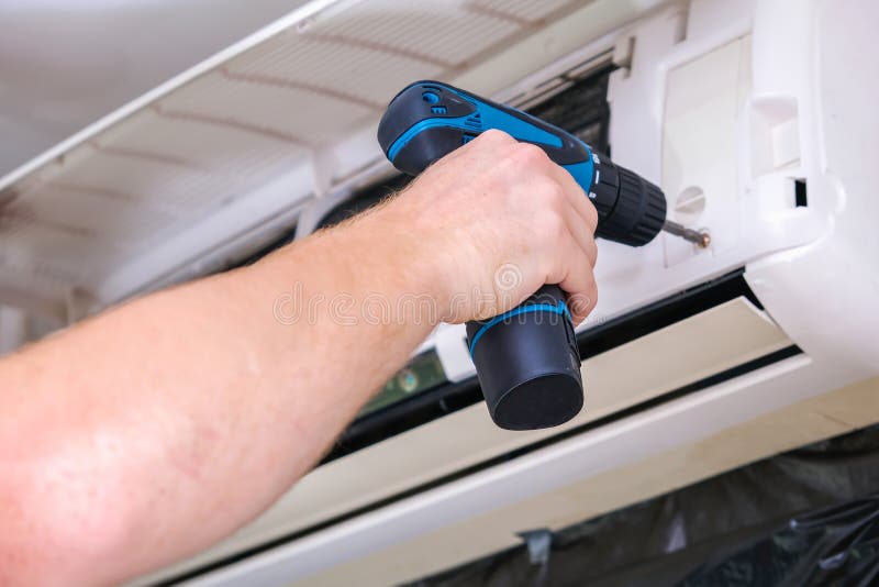 Man Disassembles an Air Conditioner for Repair and Cleaning. Split ...