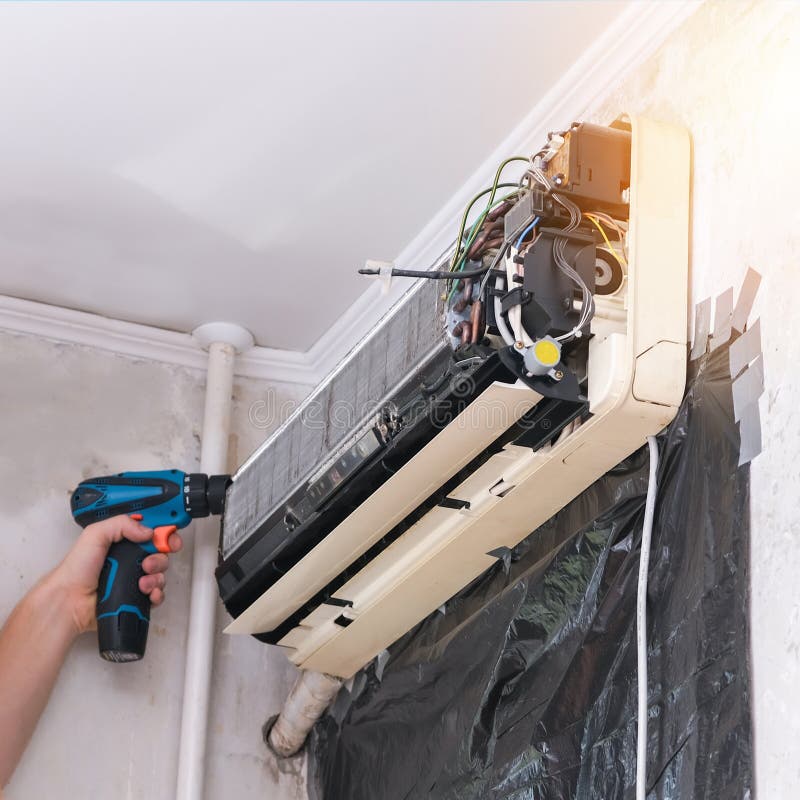 Man Disassembles an Air Conditioner for Repair and Cleaning. Split ...