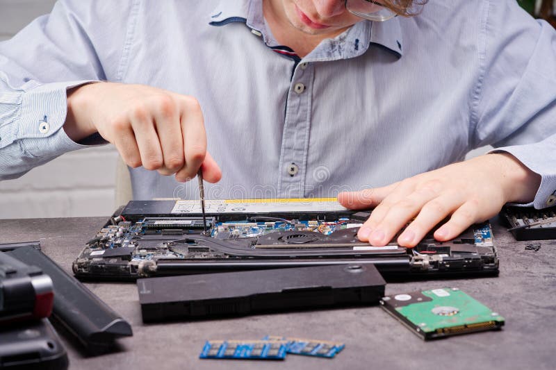 Man Disassembles a Laptop. Computer Service and Repair Concept. Laptop ...