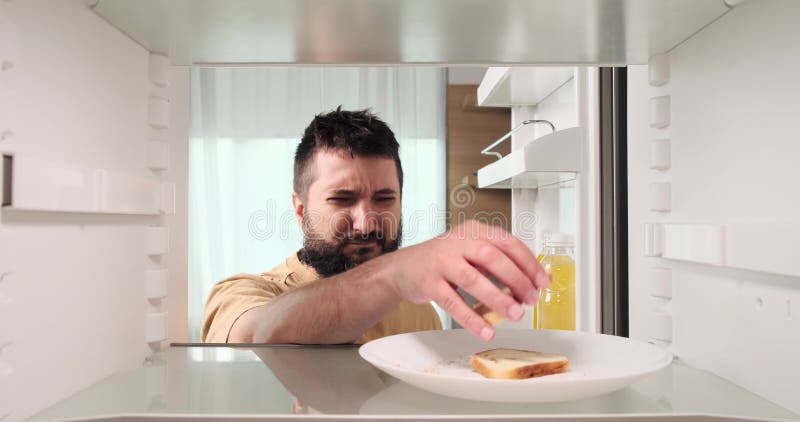 Man Discovers Stale Bread in the Refrigerator after the Party Stock ...