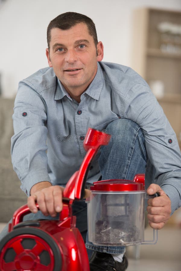 Man Dismantling Vacuum Cleaner To Empty Out Dust Stock Photo - Image of ...