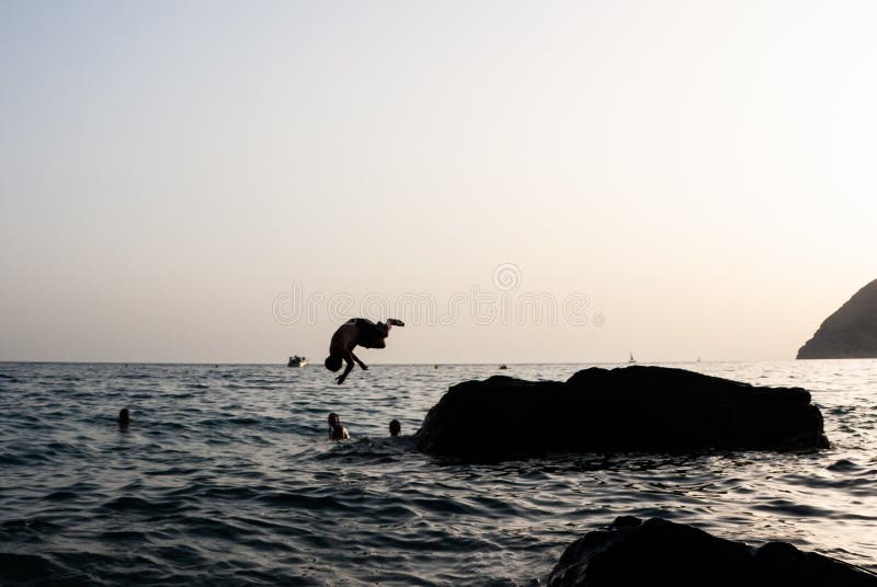 Man Diving from a Cliff in the Sea Doing a Flip Editorial Image - Image ...
