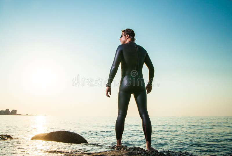 Man in Diving Suit Standing in Waves Stock Photo - Image of diving ...