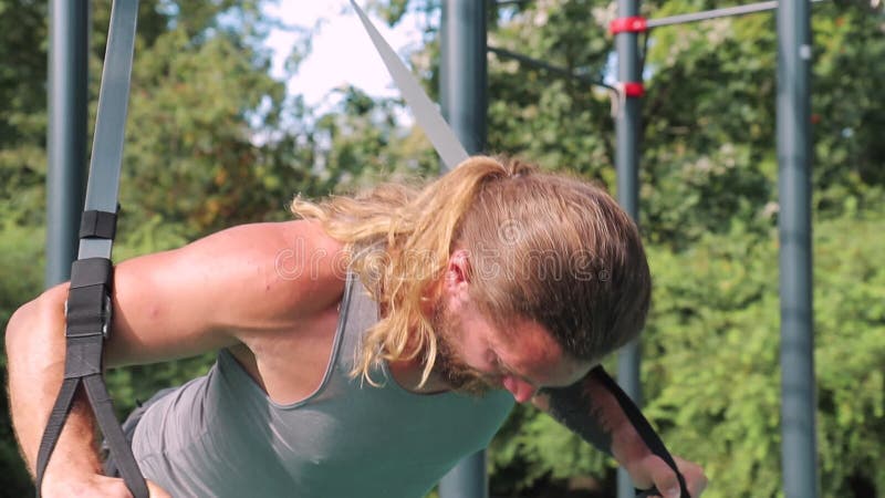 Man Do Push-ups on Playground among the Trees, Total Body Resistance ...
