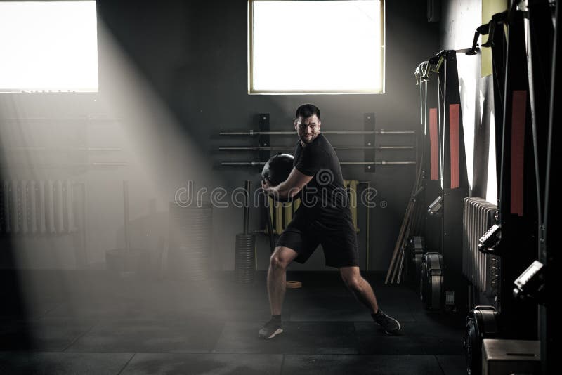 Man Do Strong Exercises with Heavy Ball . Stock Image - Image of ...