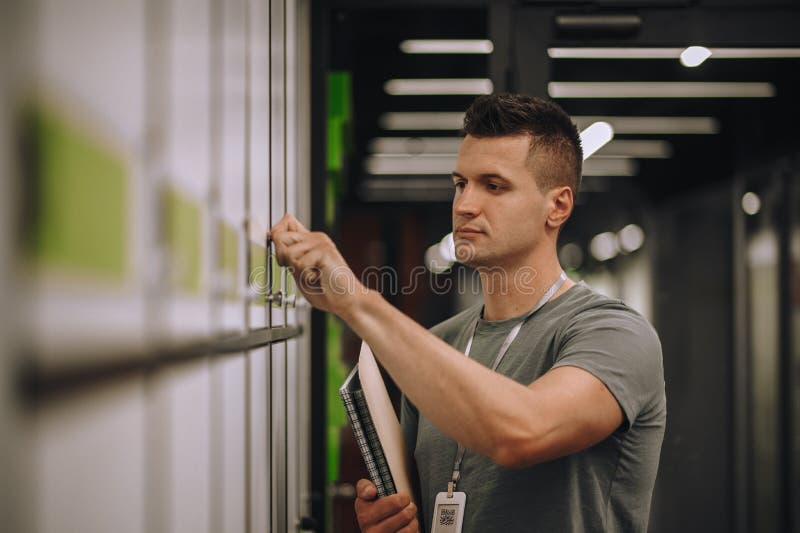 Man with Documents Closing Locker in Office Corridor Stock Photo ...