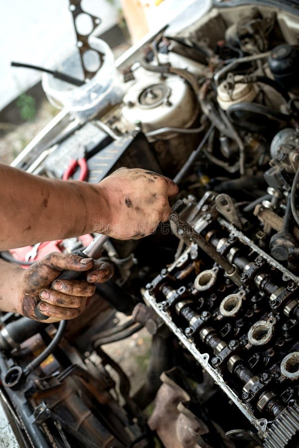 A Man Does a Broach of the Head. Makes Car Repair, Engine ...
