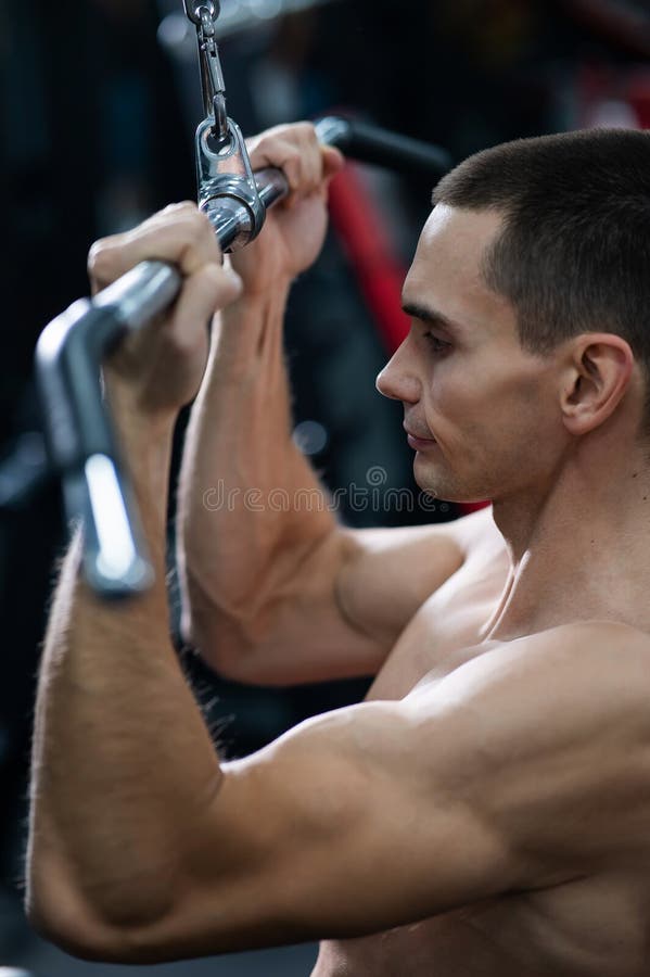 A Man Does a Chest Pulldown in the Gym. Stock Photo - Image of heavy ...