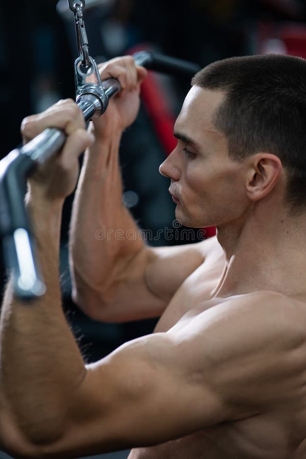 A Man Does a Chest Pulldown in the Gym. Stock Photo - Image of body ...