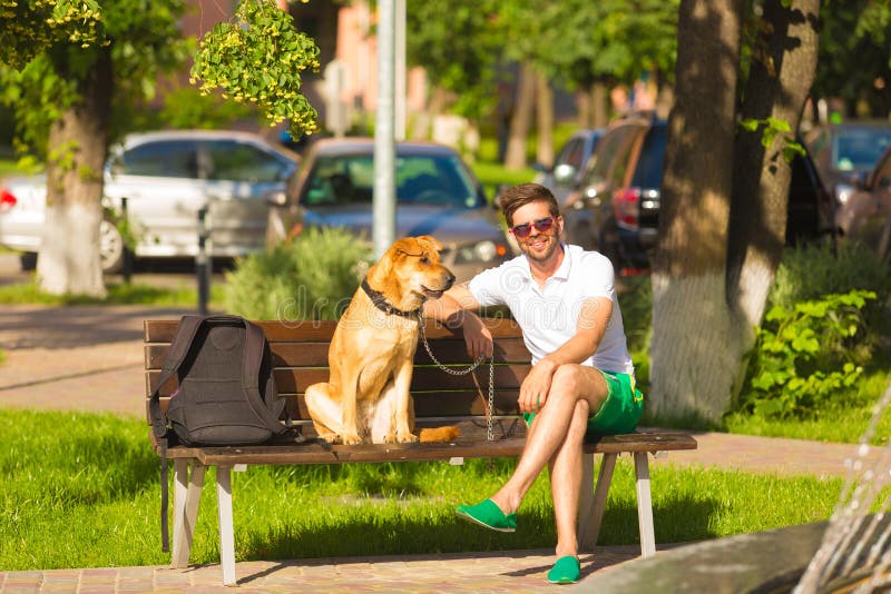 Man with Dog on Bench in Park. Stock Image - Image of human, background ...