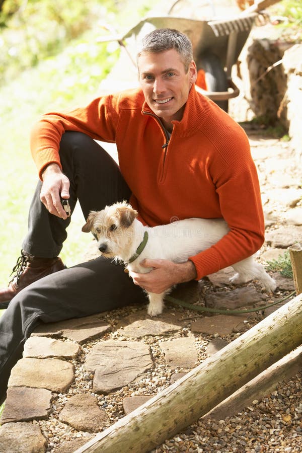 Man with Dog on Break from Gardening Stock Photo - Image of break, rest ...