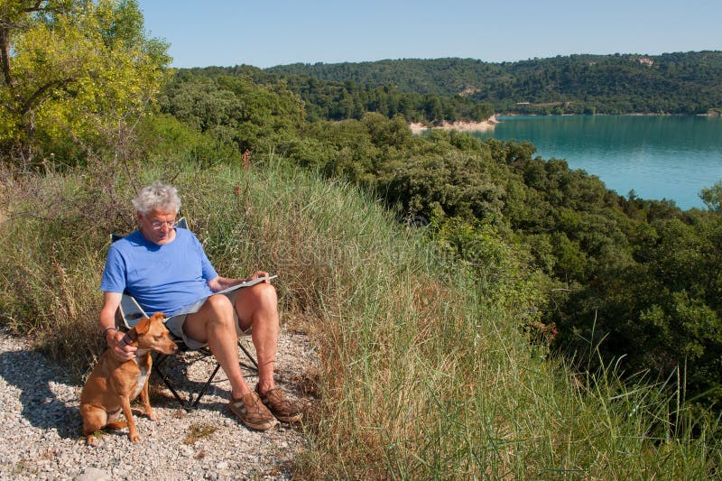 Man with Dog Sitting in French Landscape Stock Image - Image of croix ...
