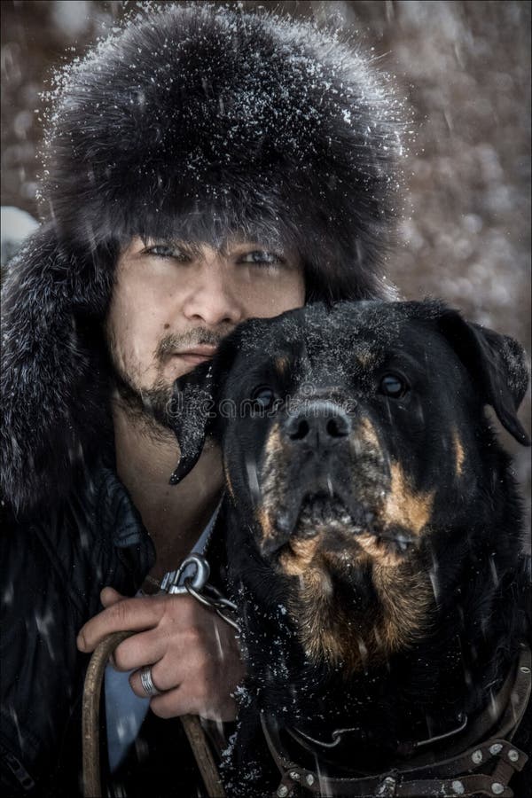 Man with Blue Eyes and a Dog in a Winter Snow Park Stock Image - Image ...